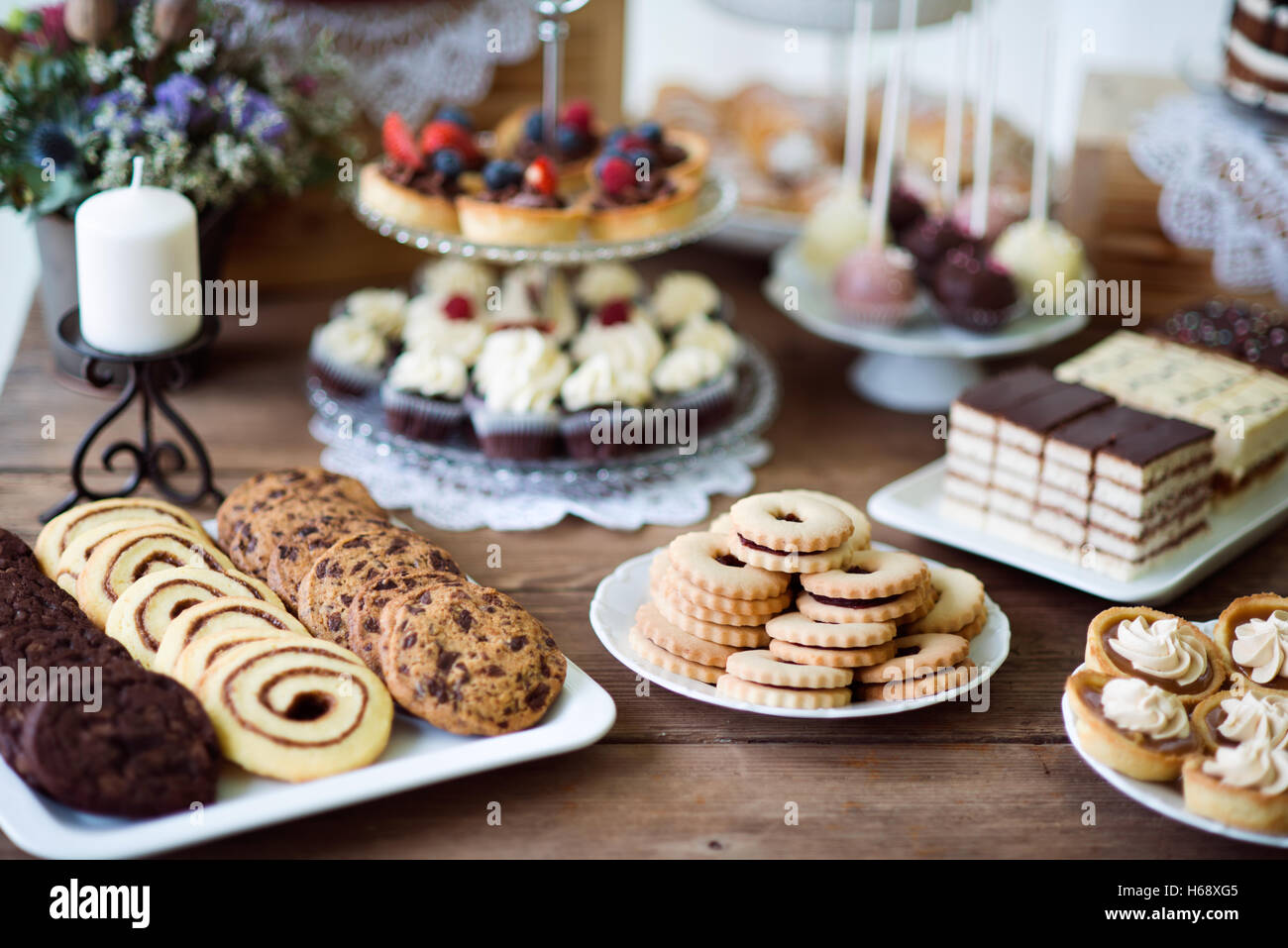 Table with various cookies, tarts, cakes, cupcakes and cakepops Stock ...