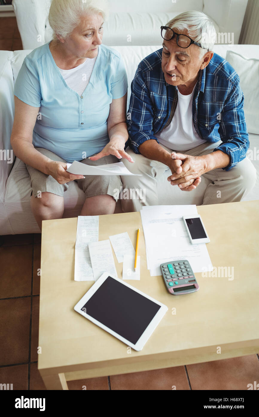 Senior couple interacting while checking the bills Stock Photo - Alamy