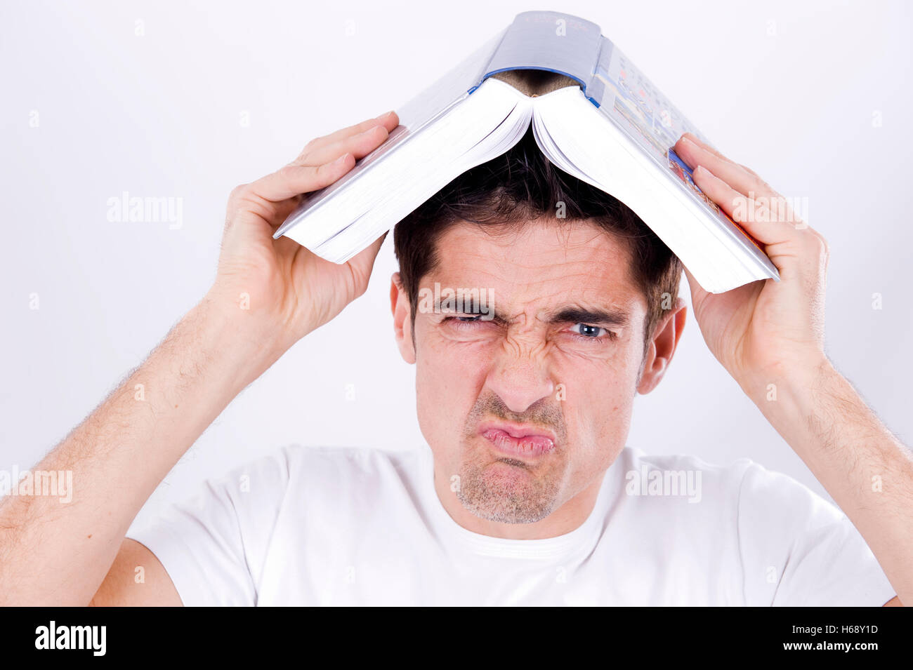 Man with a book on head Stock Photo - Alamy