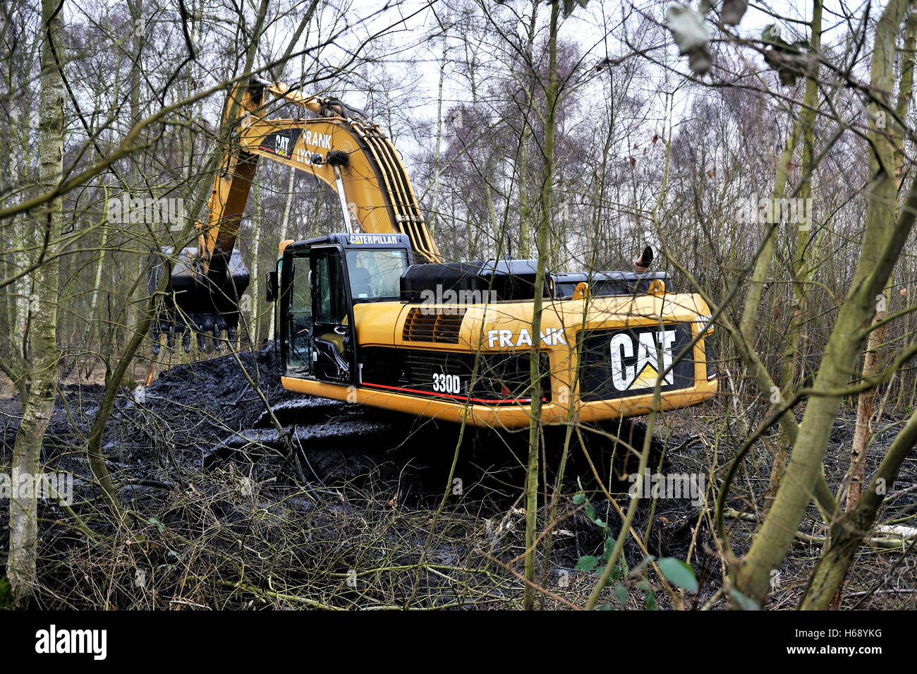A large digger in the process of attempting to pull another smaller ...