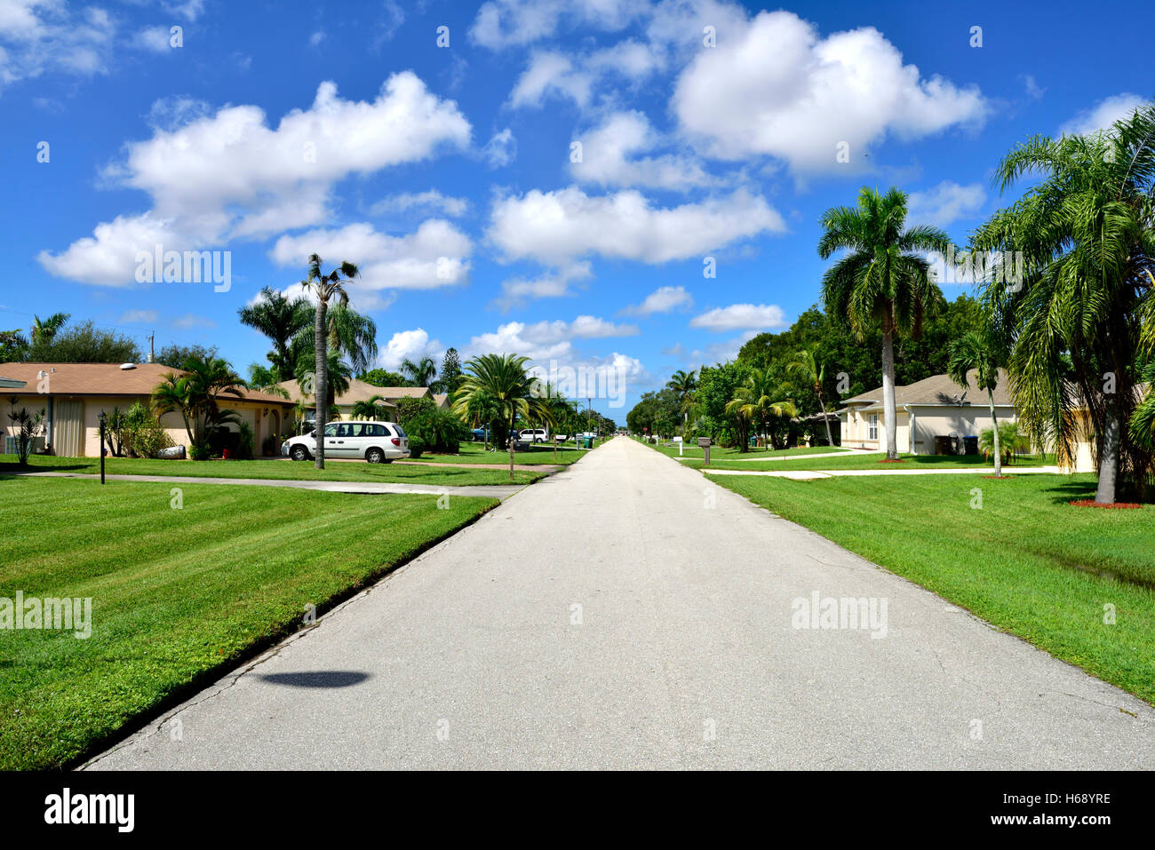 Long straight American residential road with homes, lawns, Cape Coral ...