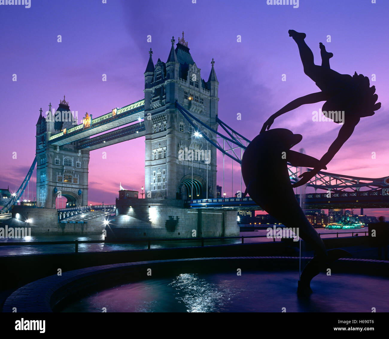 Tower Bridge at dusk with Girl with a Dolphin statue, London Stock ...