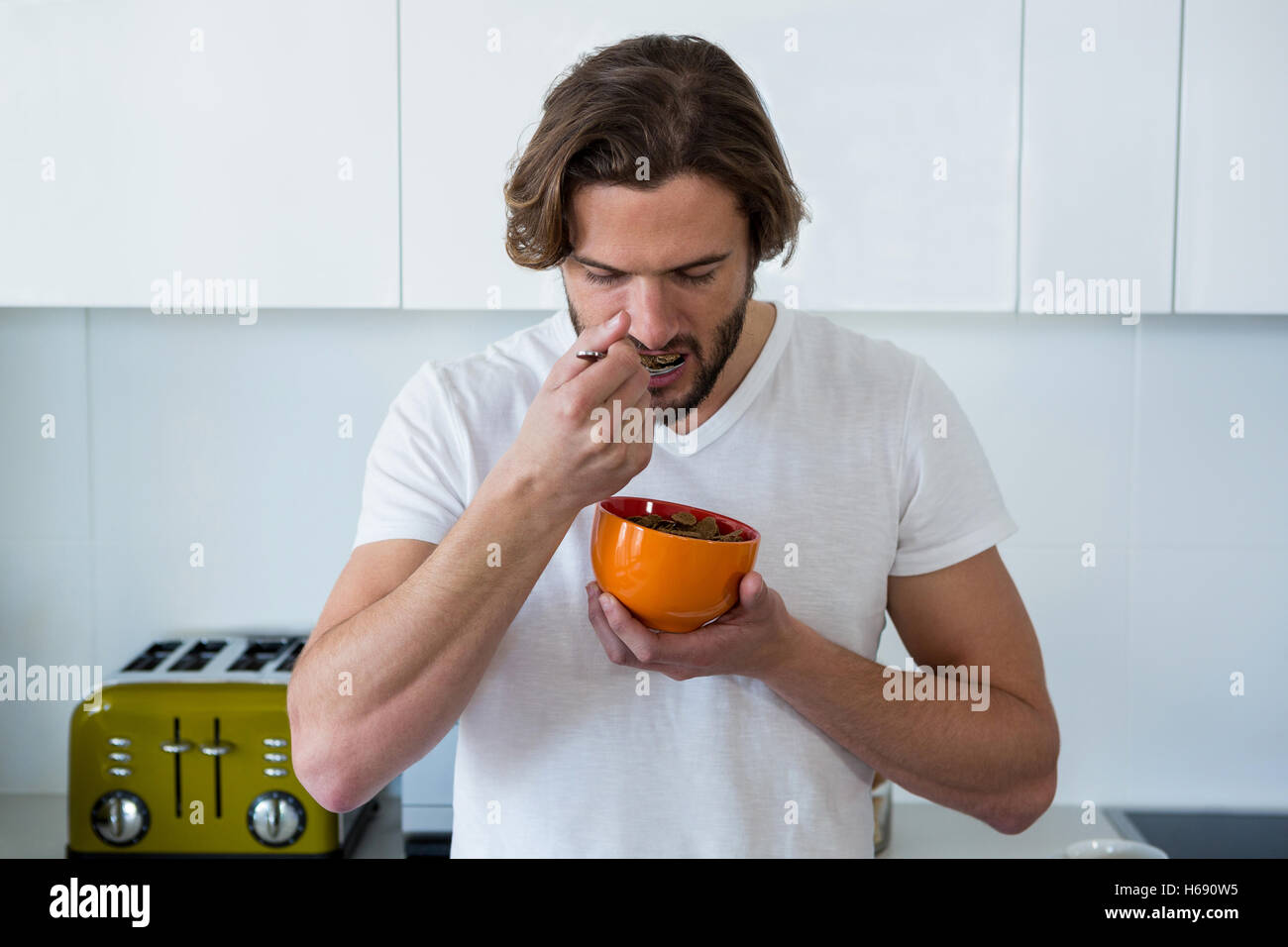 Man having breakfast in kitchen Stock Photo - Alamy