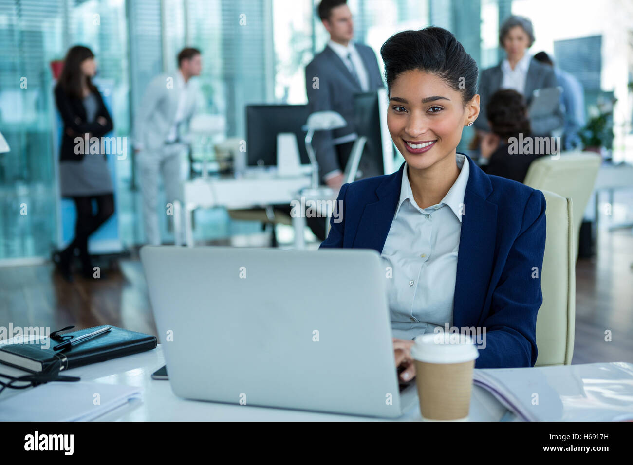 Businesswoman working on laptop in the office Stock Photo - Alamy