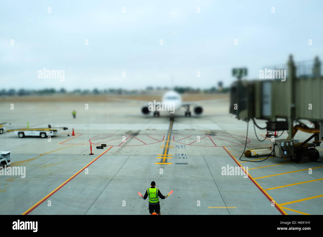 Guide waves an airplane into the gate Stock Photo - Alamy