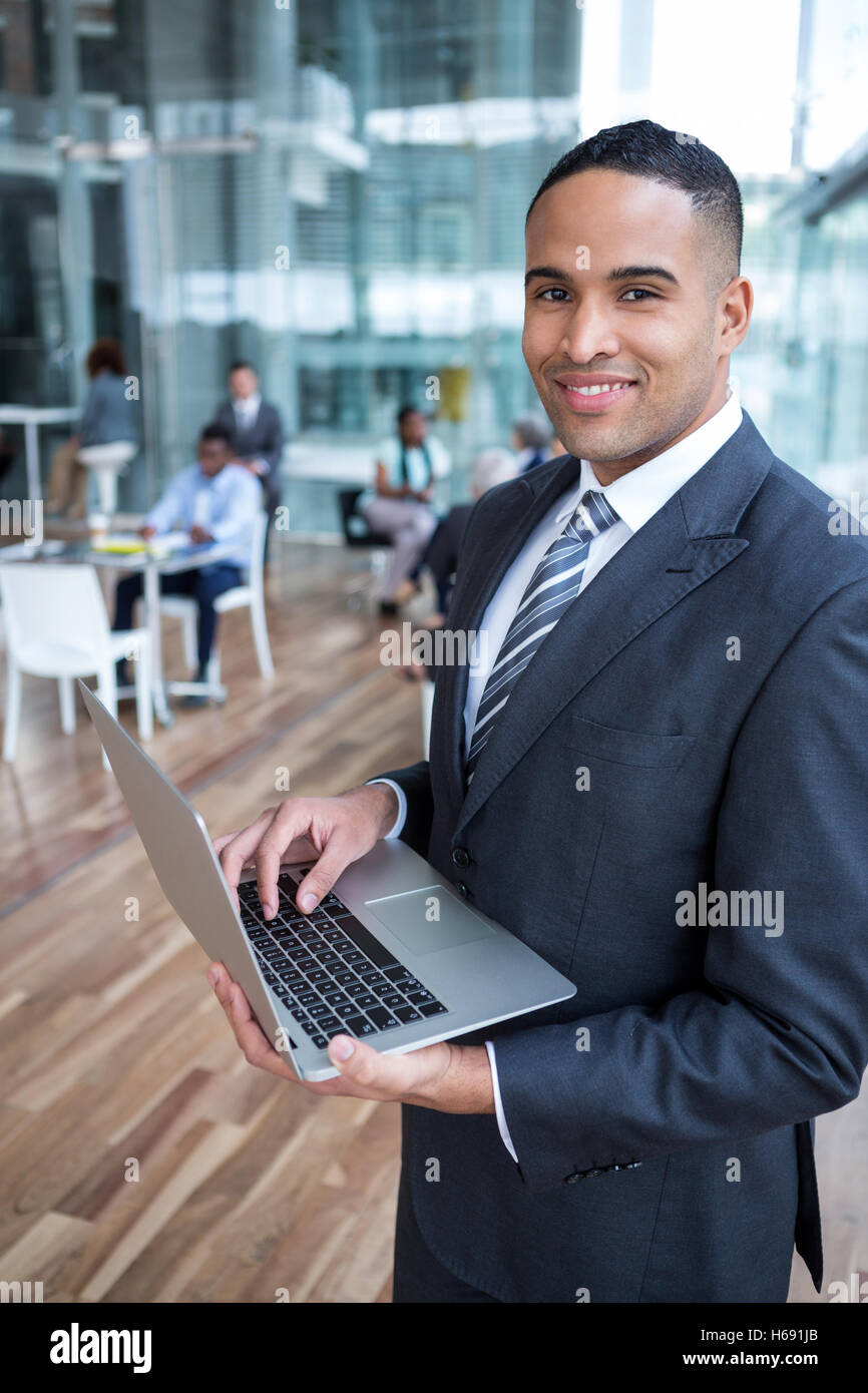 Businessman smiling using laptop hi-res stock photography and images ...