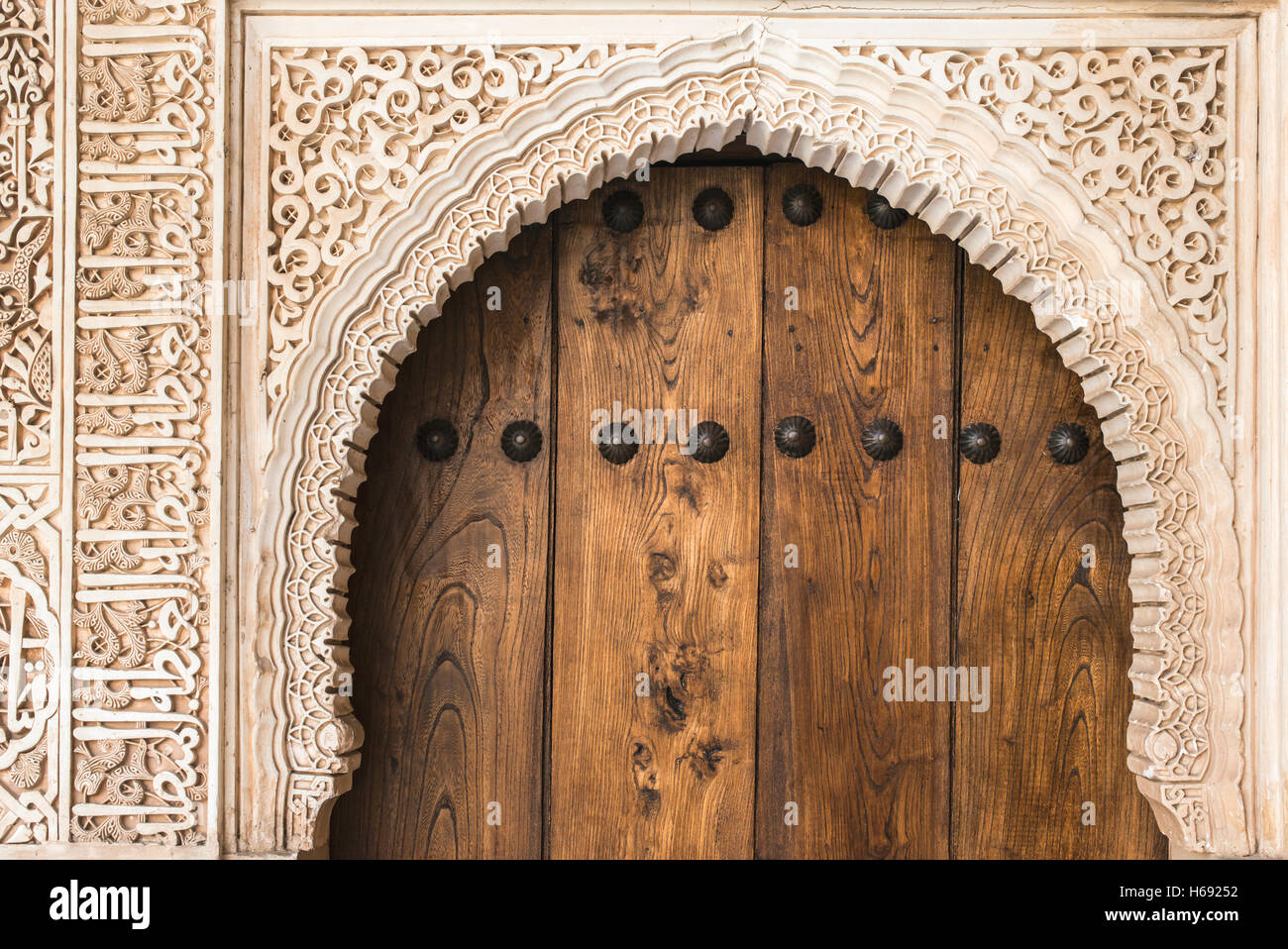 Islamic ornaments on wall. Arab symbols. Wooden door Stock Photo - Alamy