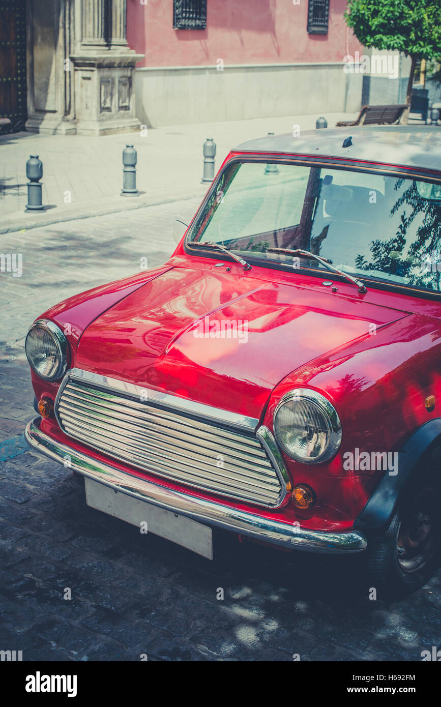 Vintage small red car on the street Stock Photo - Alamy