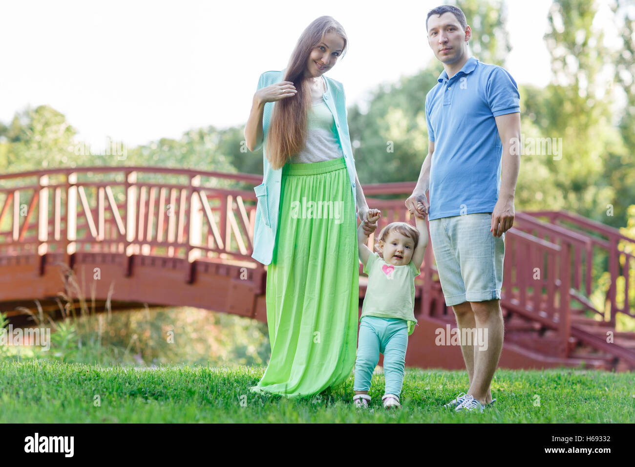 Young parents with baby daughter next to bridge Stock Photo - Alamy