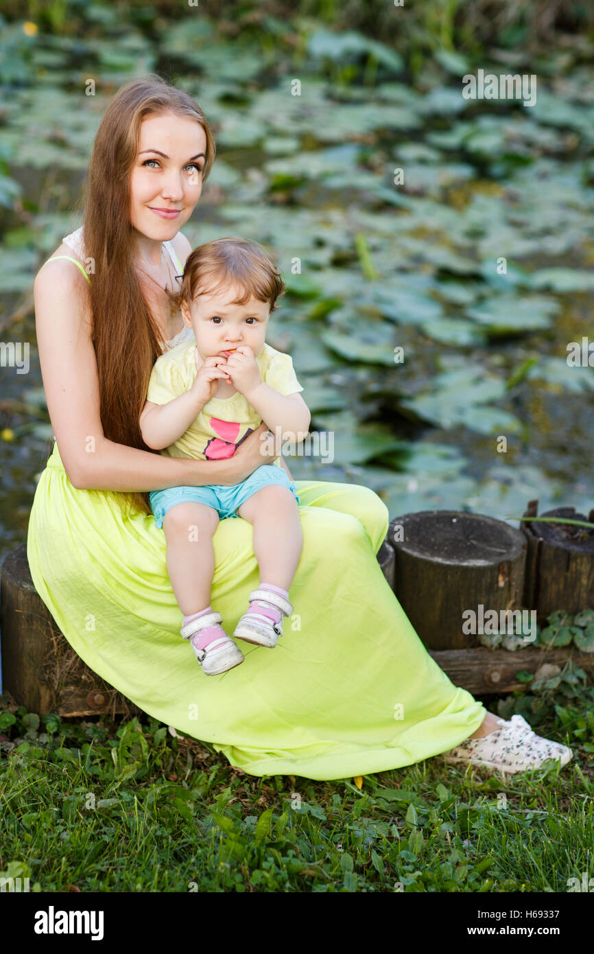Baby girl sitting on stump hi-res stock photography and images - Alamy