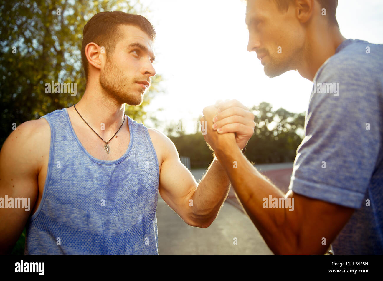 Two handsome athlete men handshake outdoors Stock Photo - Alamy