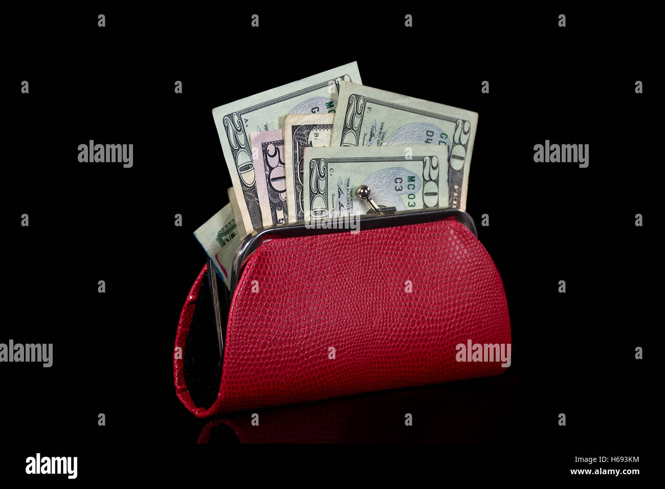 money in red change purse isolated on black Stock Photo - Alamy