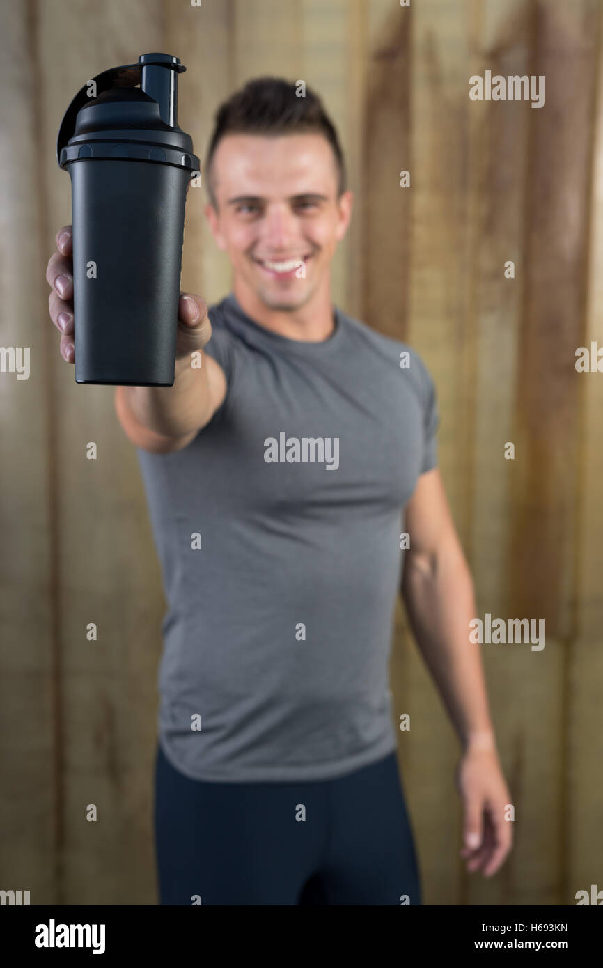 Muscular fitness male bodybuilder holding protein shake bottle ready ...