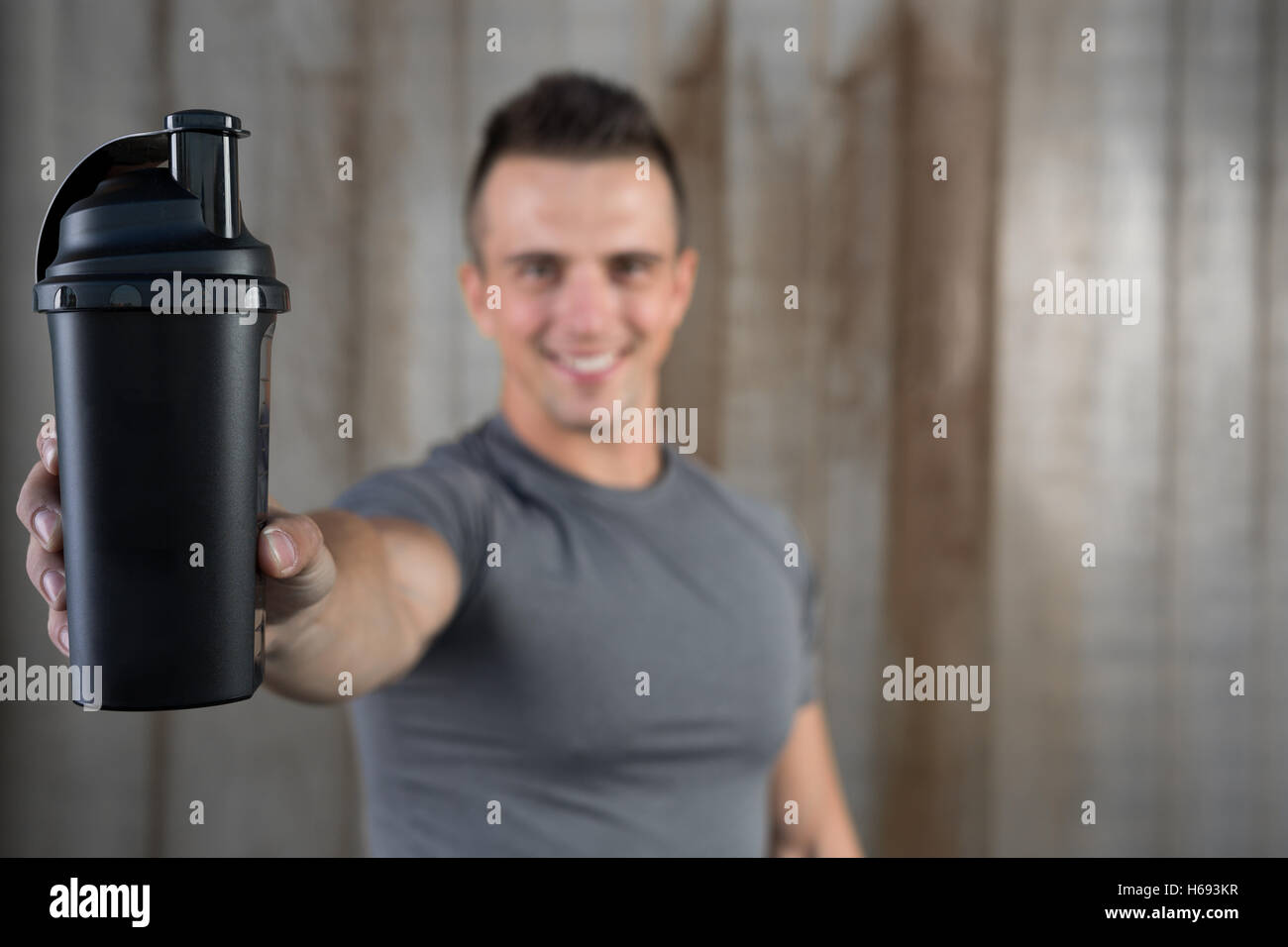 Muscular fitness male bodybuilder holding protein shake bottle ready ...