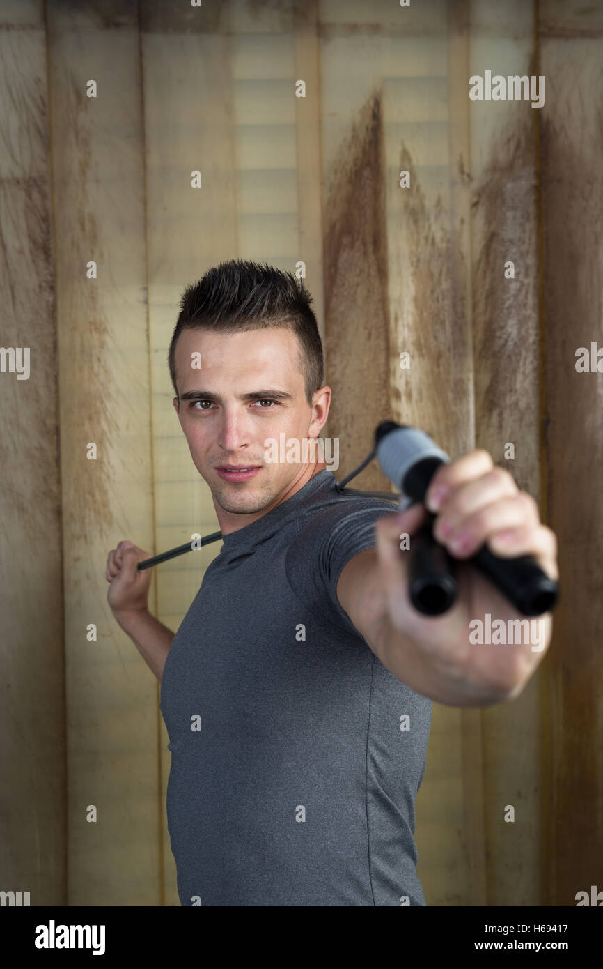Muscular man skipping rope. Portrait of muscular young man exercising ...