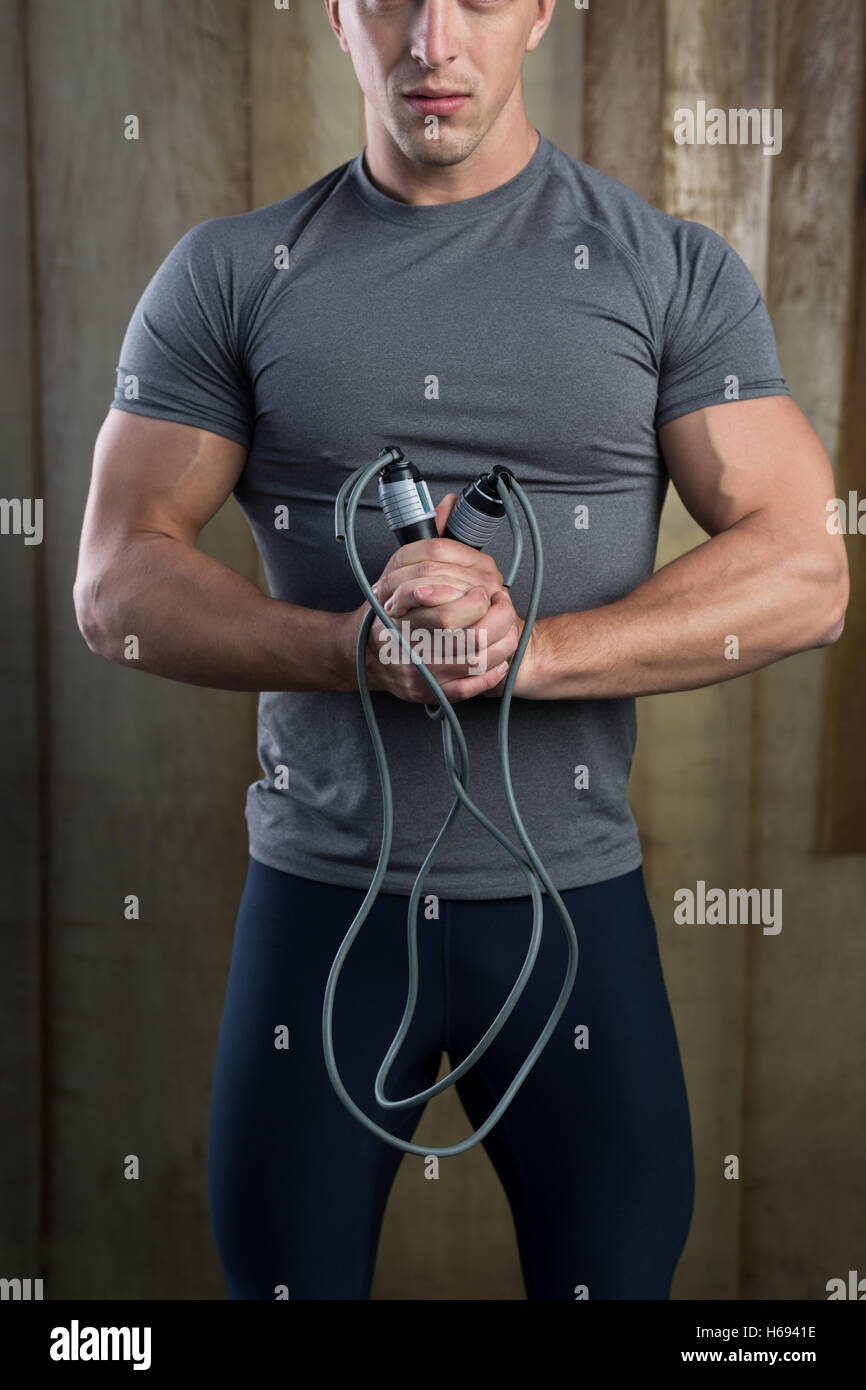 Muscular man skipping rope. Portrait of muscular young man exercising ...