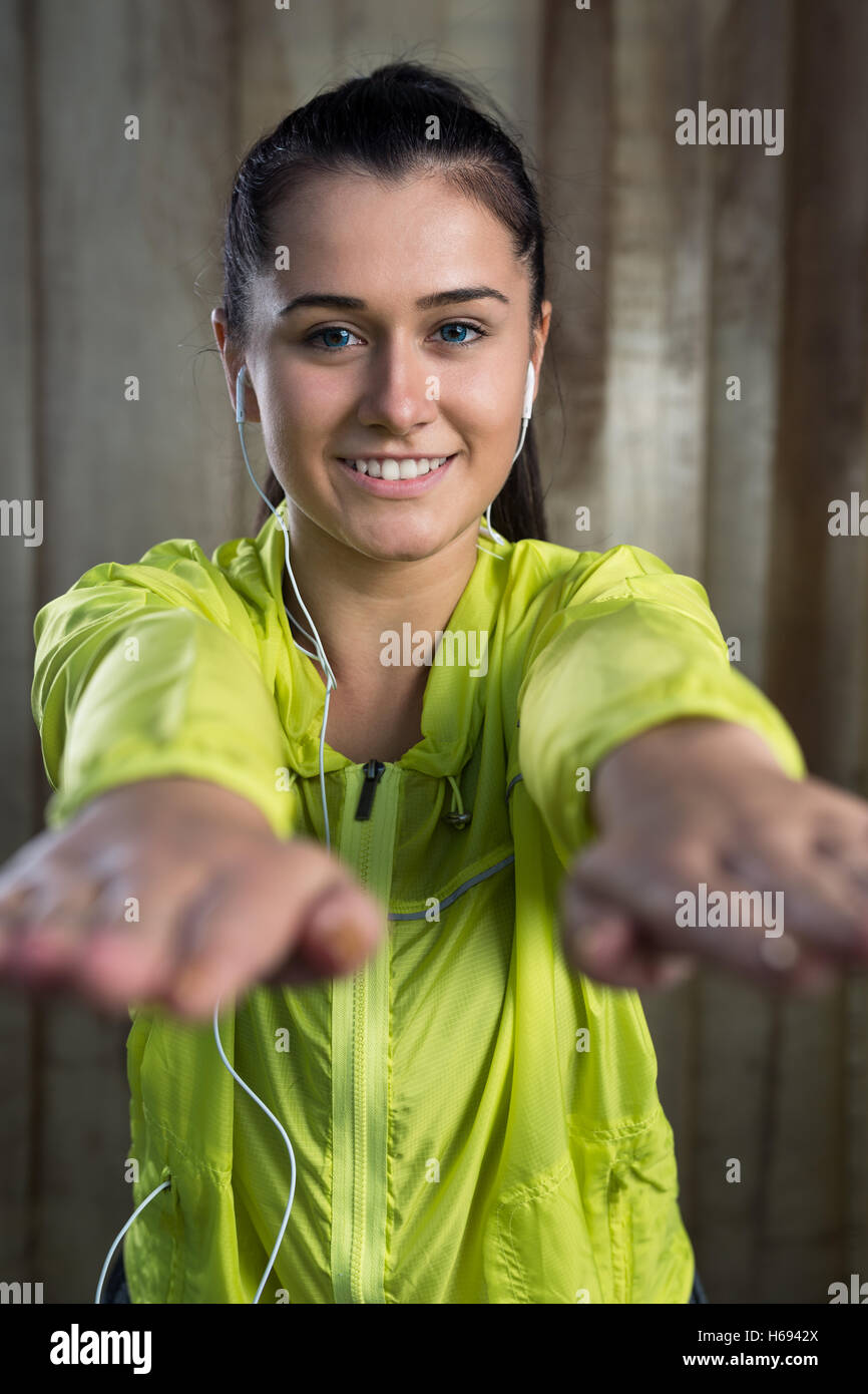 Deep squat. Front view of young beautiful woman in sportswear doing ...