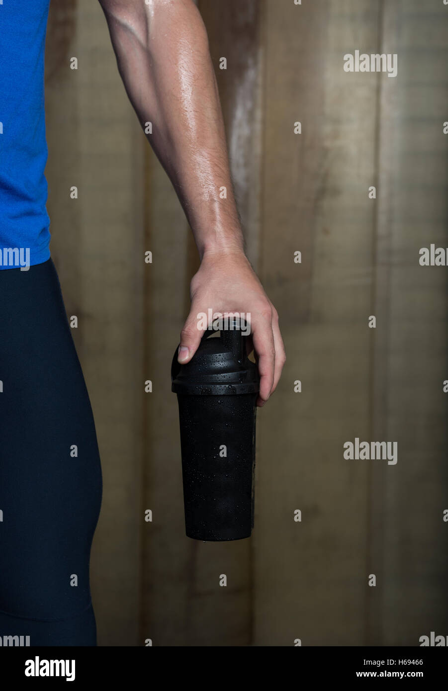 Muscular fitness male bodybuilder holding protein shake bottle ready ...