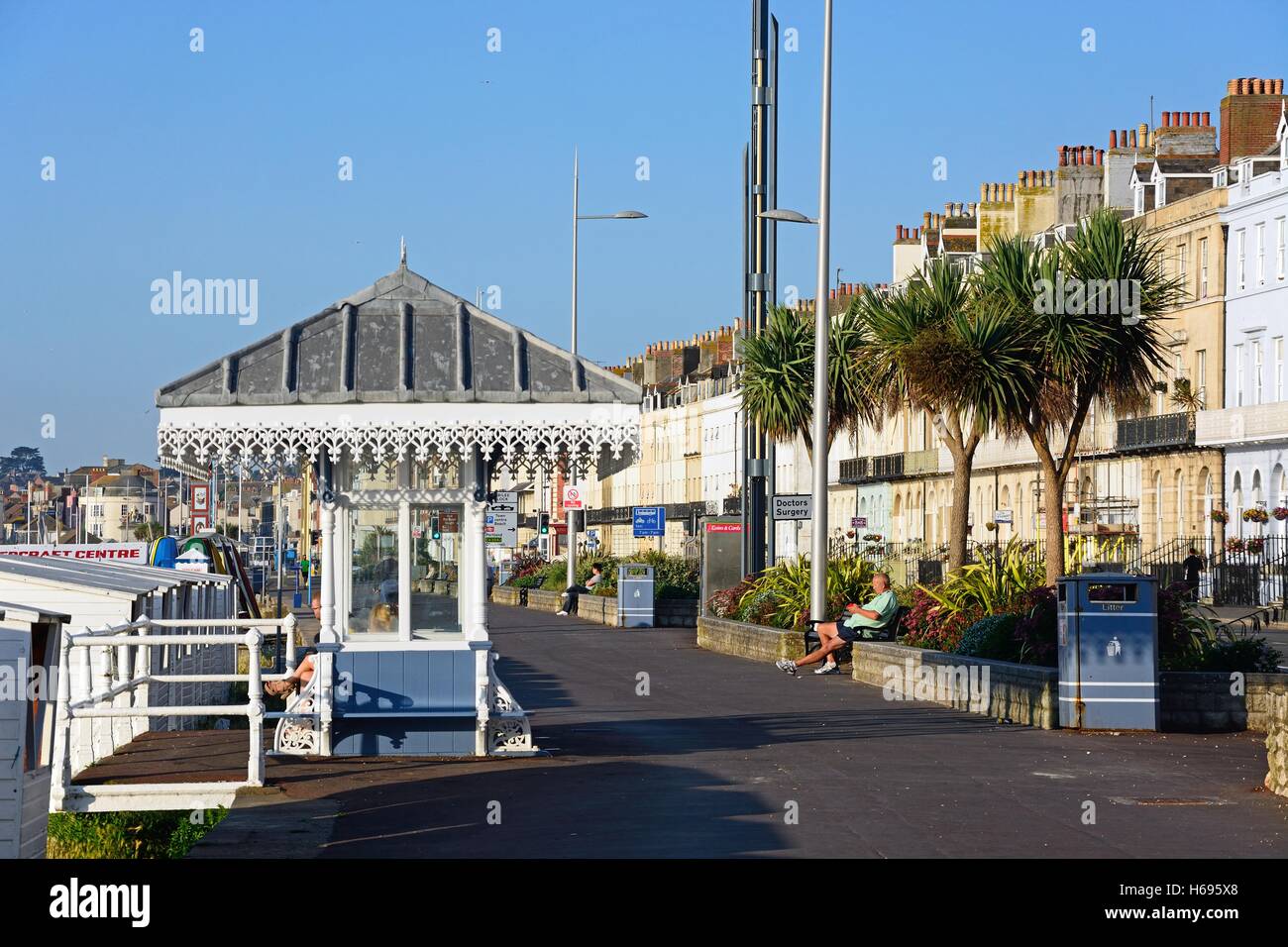 Covered bench along the Esplanade promenade with Georgian guesthouses ...