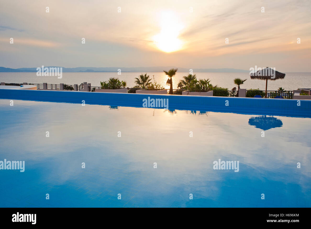Luxury hotel pool at sunset Stock Photo - Alamy