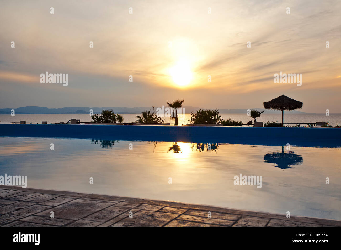 Luxury hotel pool at sunset Stock Photo - Alamy