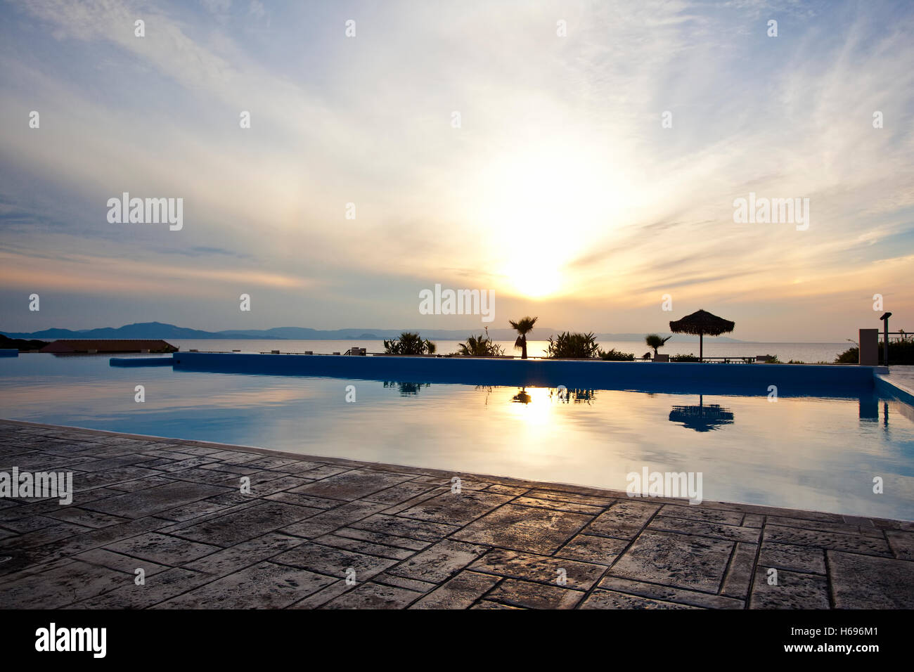 Luxury hotel pool at sunset Stock Photo - Alamy