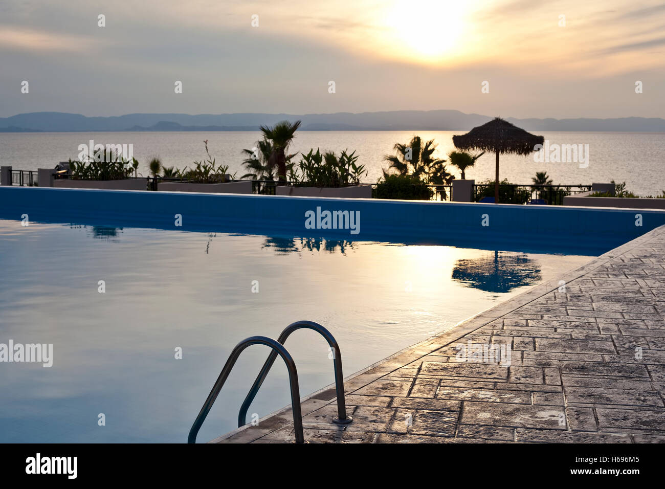 Luxury hotel pool at sunset Stock Photo - Alamy