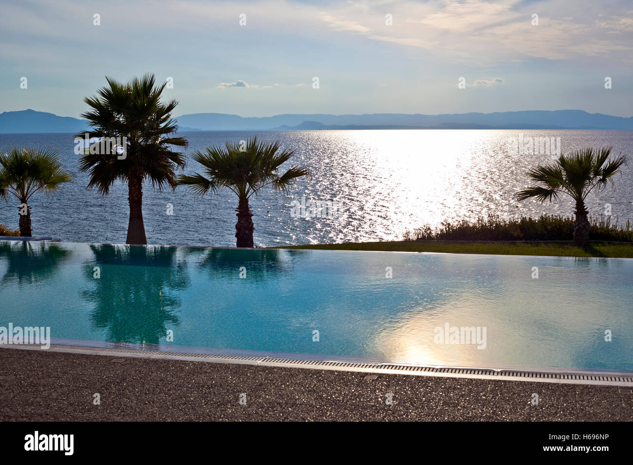 Luxury hotel pool at sunset Stock Photo - Alamy