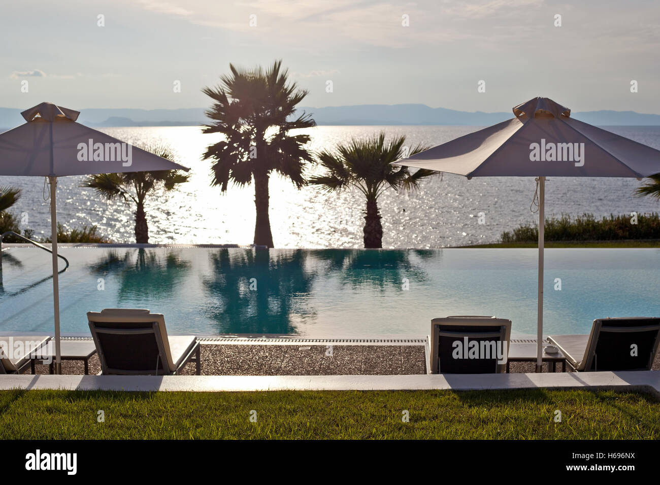 Luxury hotel pool at sunset Stock Photo - Alamy