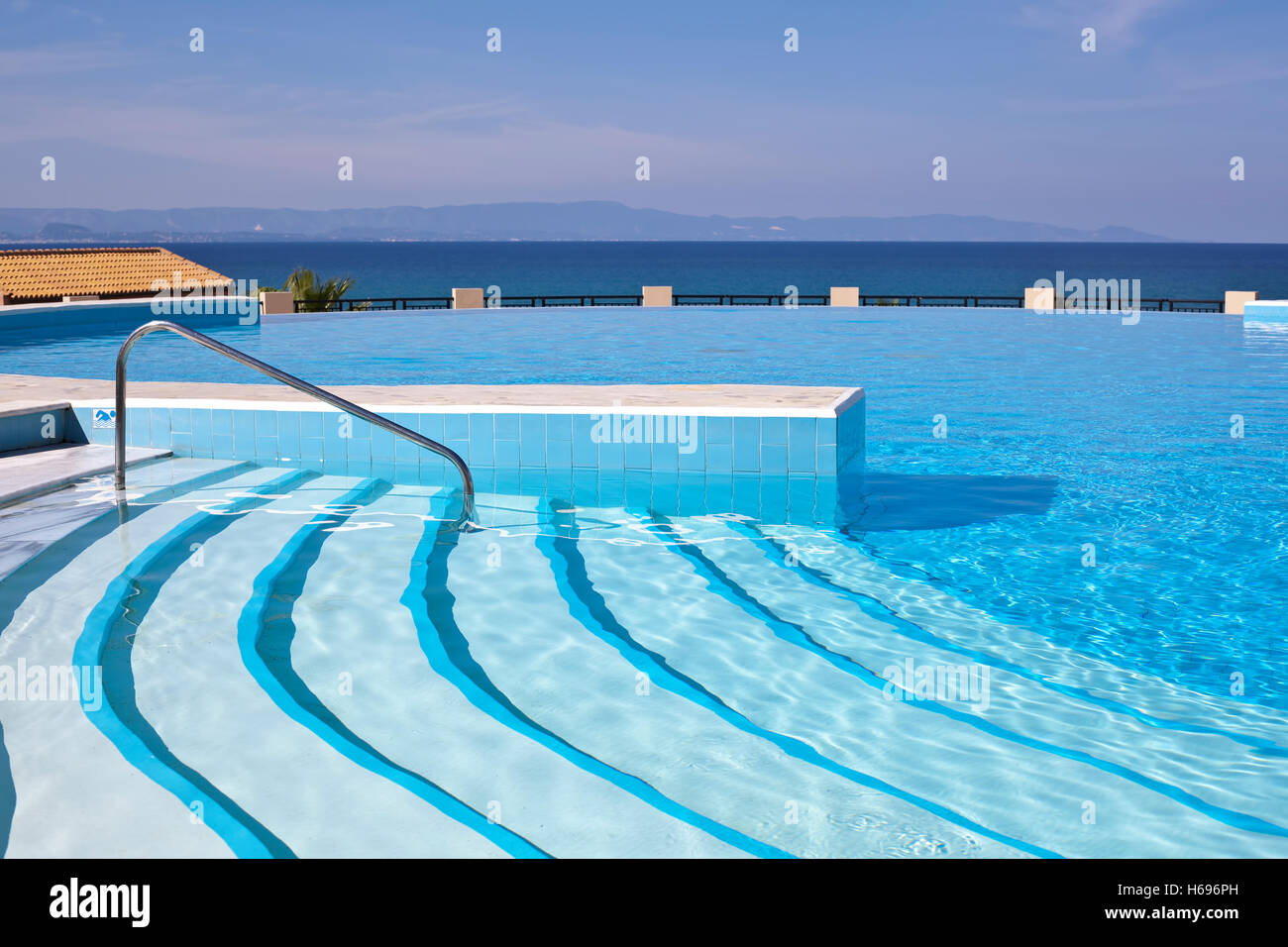 Luxury hotel pool at sunset Stock Photo - Alamy