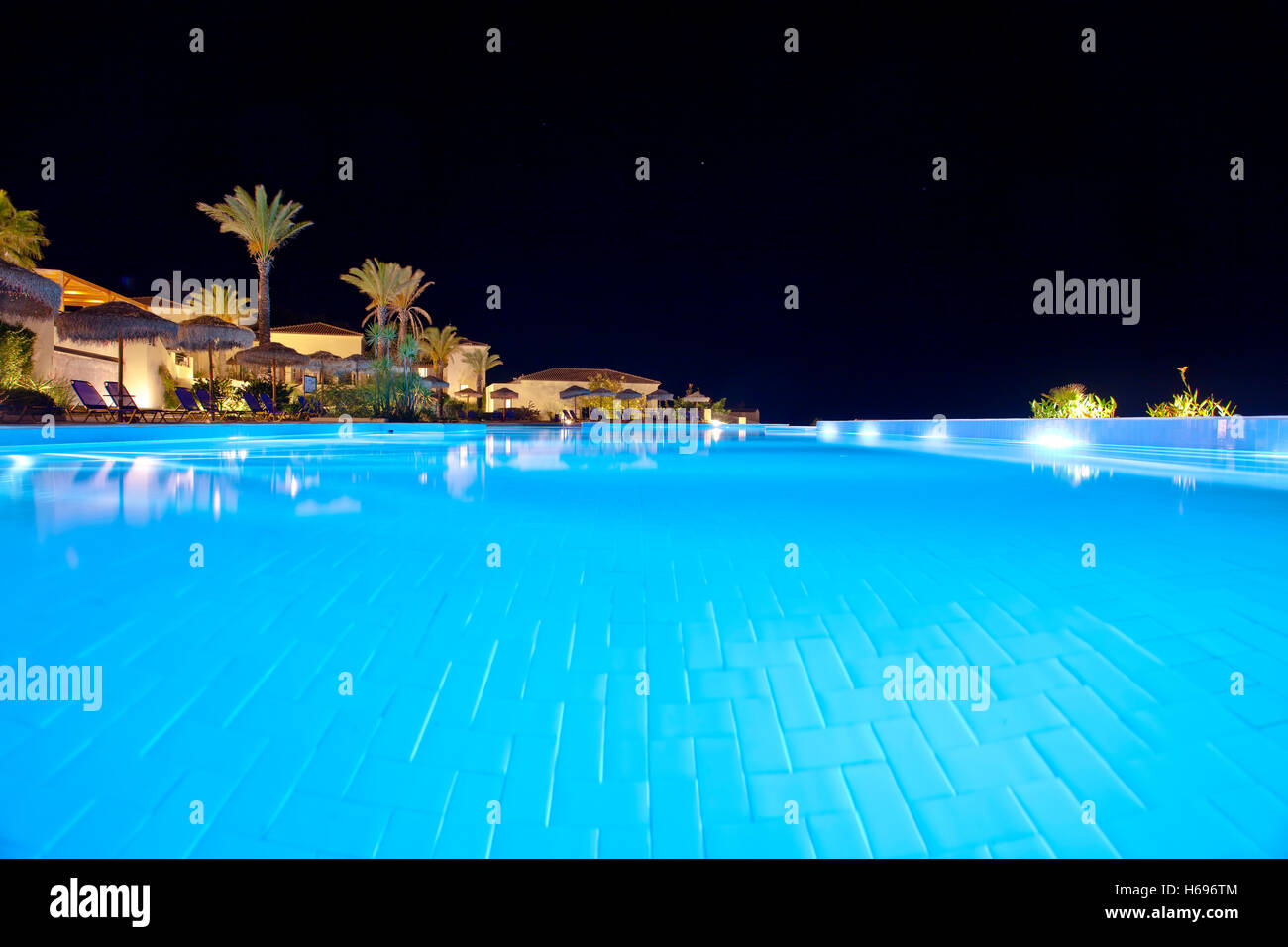 Luxury hotel pool at sunset Stock Photo - Alamy