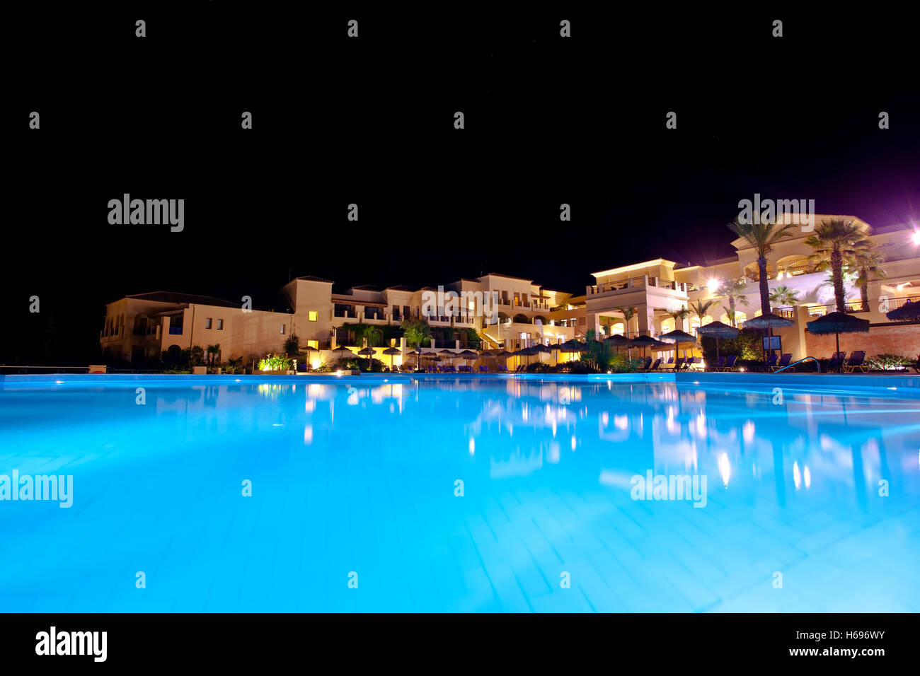 Luxury hotel pool at sunset Stock Photo - Alamy