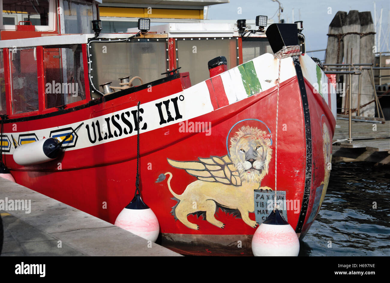 In Chioggia's fishing port a red-painted boat, the Ulisse III, displays ...