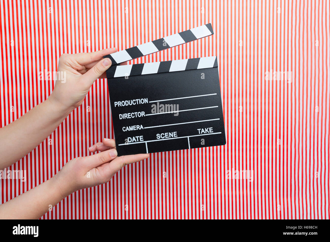 movie marker or clapper board set against a colorfull background ...