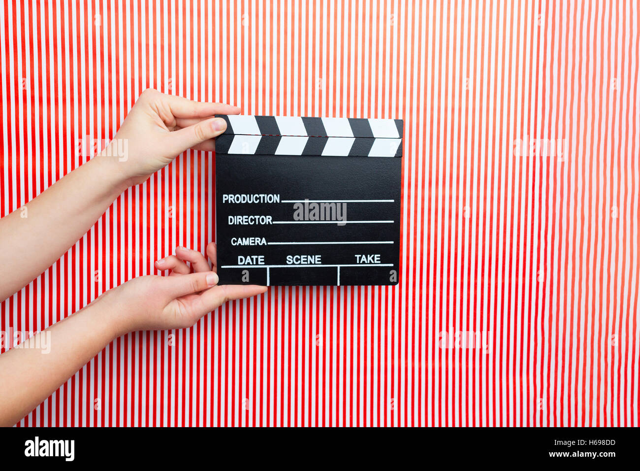 movie marker or clapper board set against a colorfull background ...
