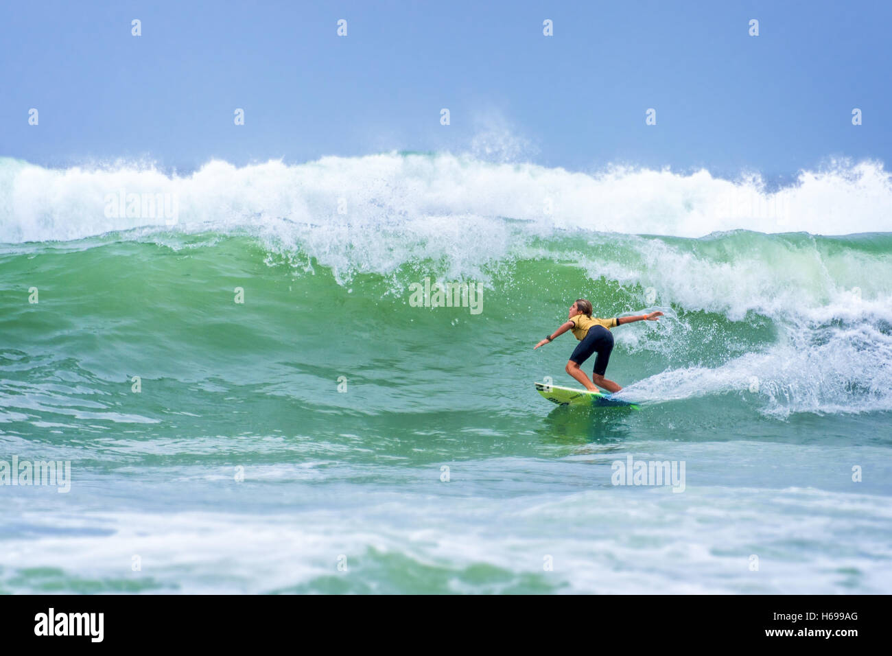 Surfer riding a huge wave during World surf league competition in ...