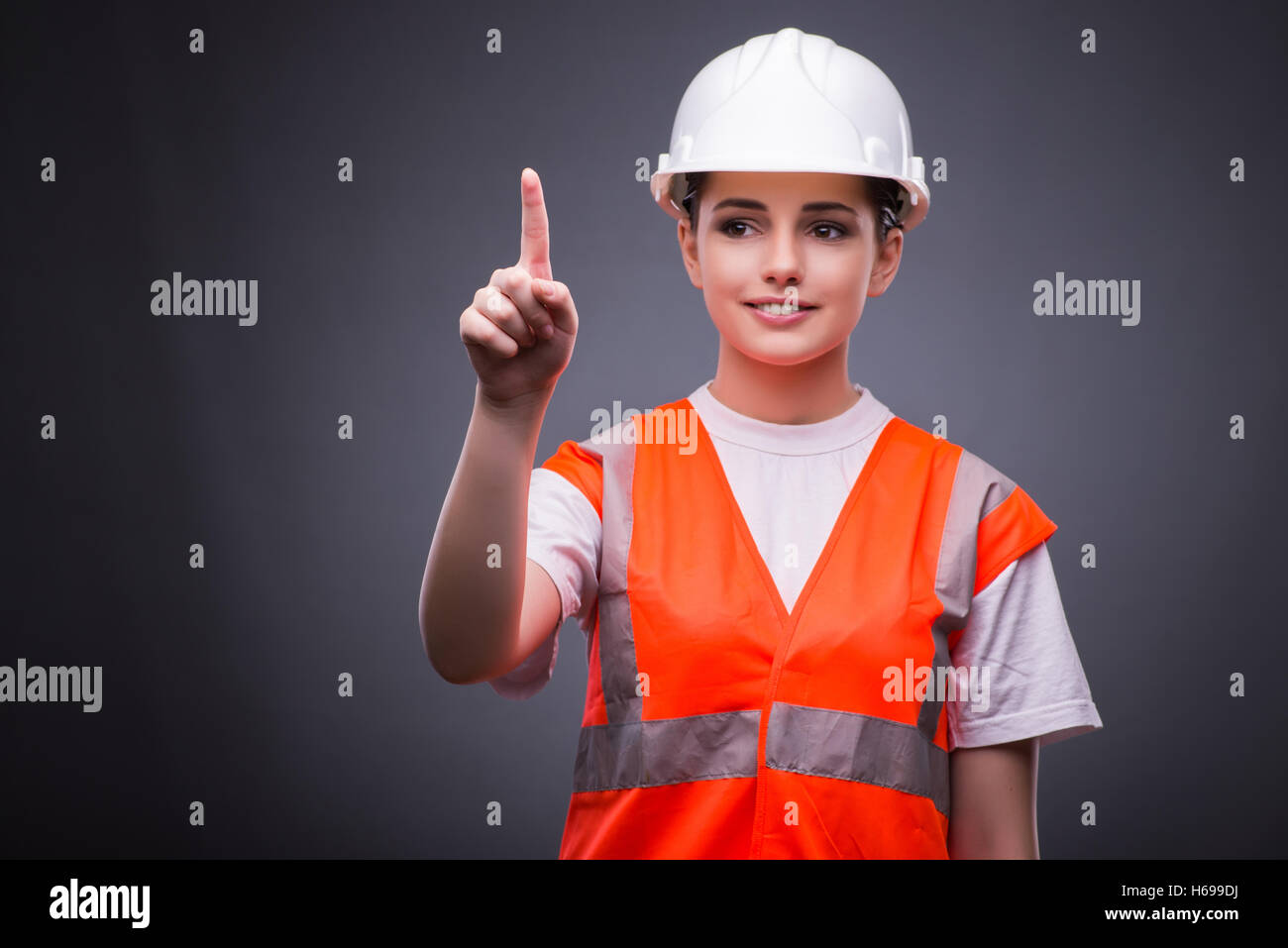 Cute construction worker pressing virtual buttons Stock Photo - Alamy