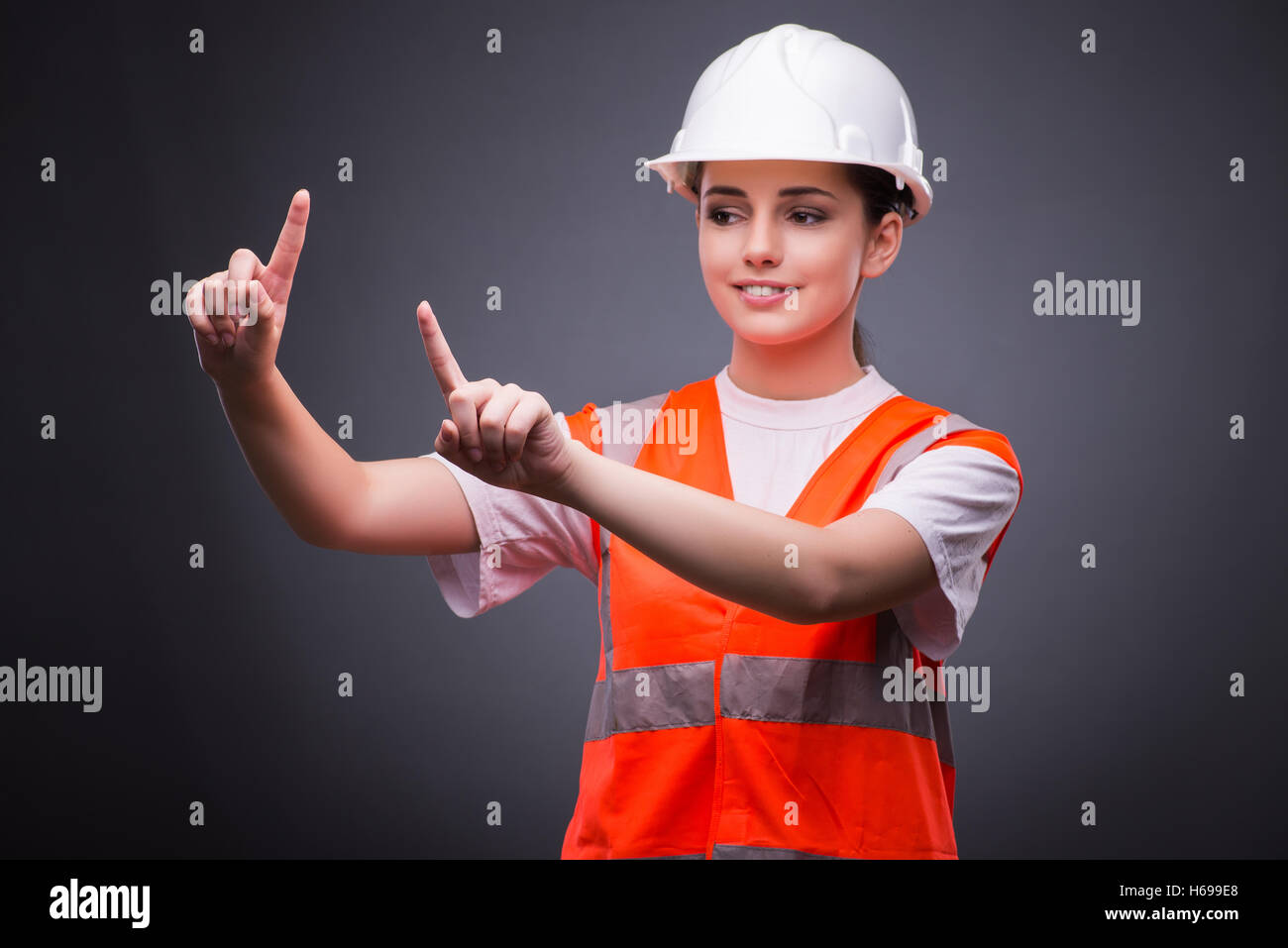 Cute construction worker pressing virtual buttons Stock Photo - Alamy