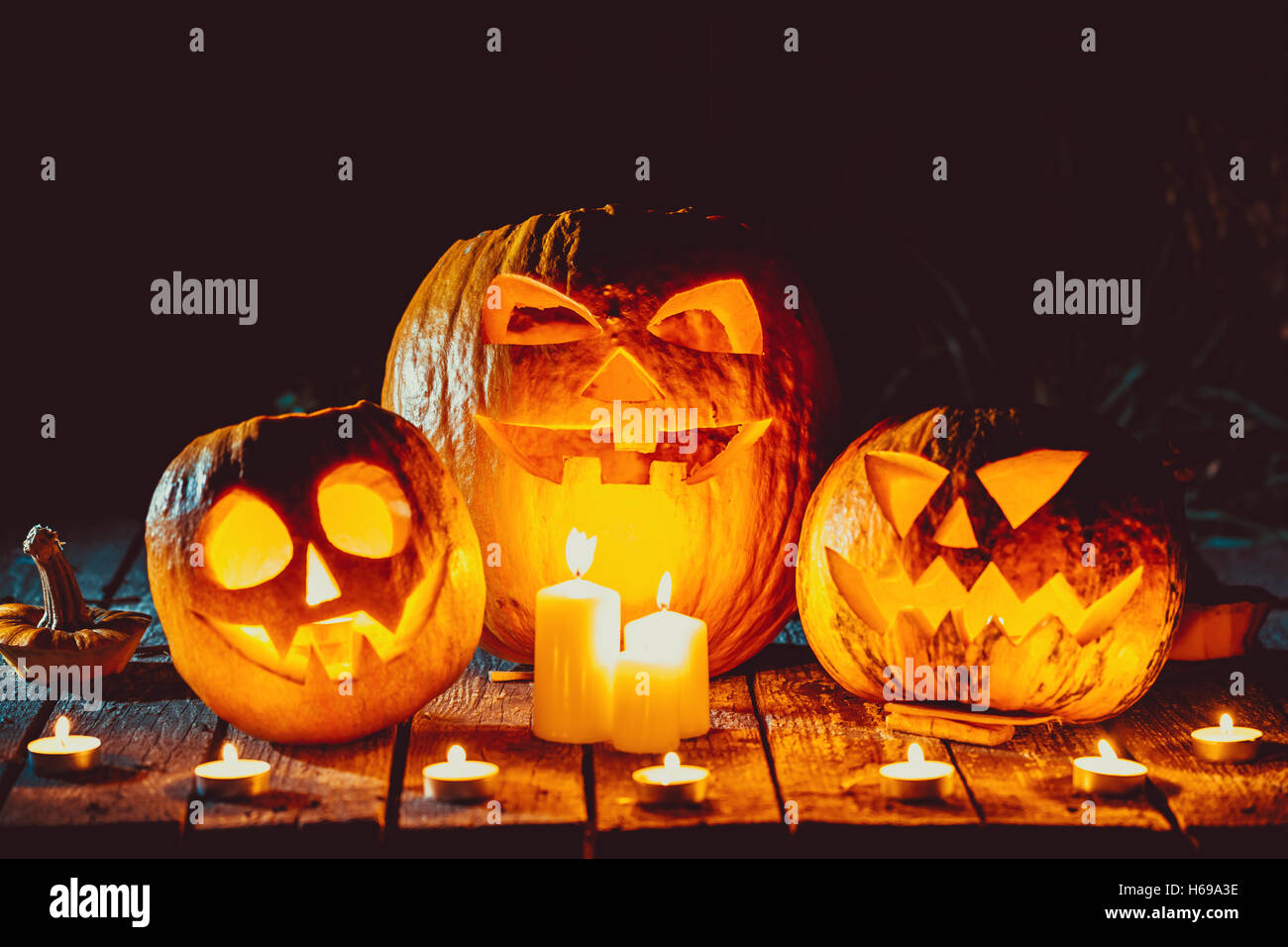 Halloween Pumpkins head jack lantern on the old boards in a spooky ...