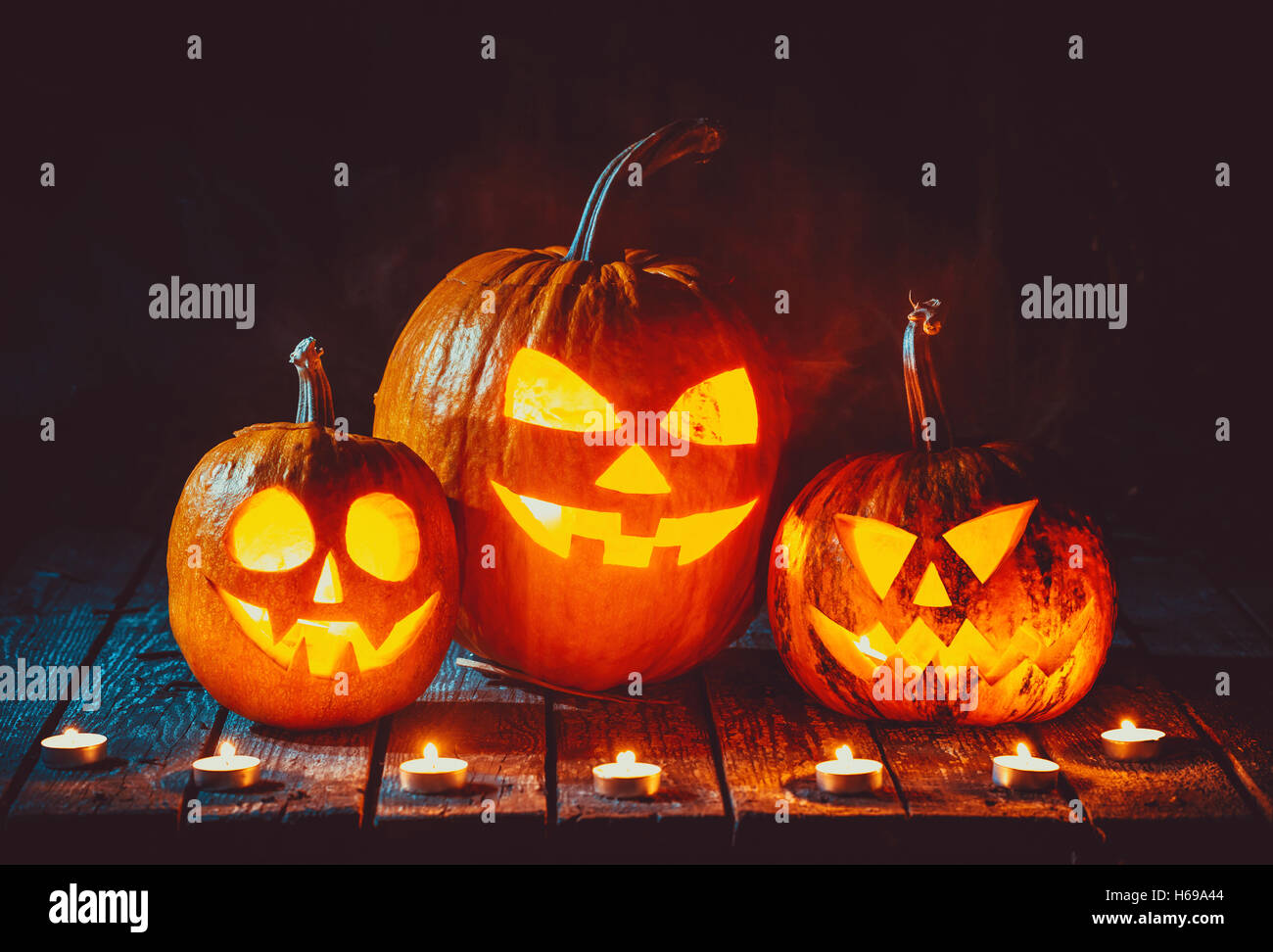 Halloween Pumpkins head jack lantern on the old boards in a spooky ...