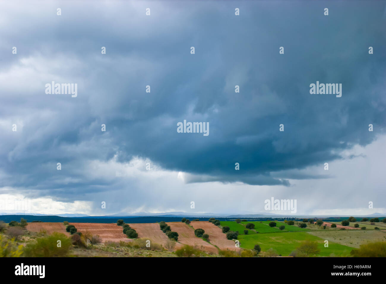 grey rainy clouds over the fields Stock Photo - Alamy
