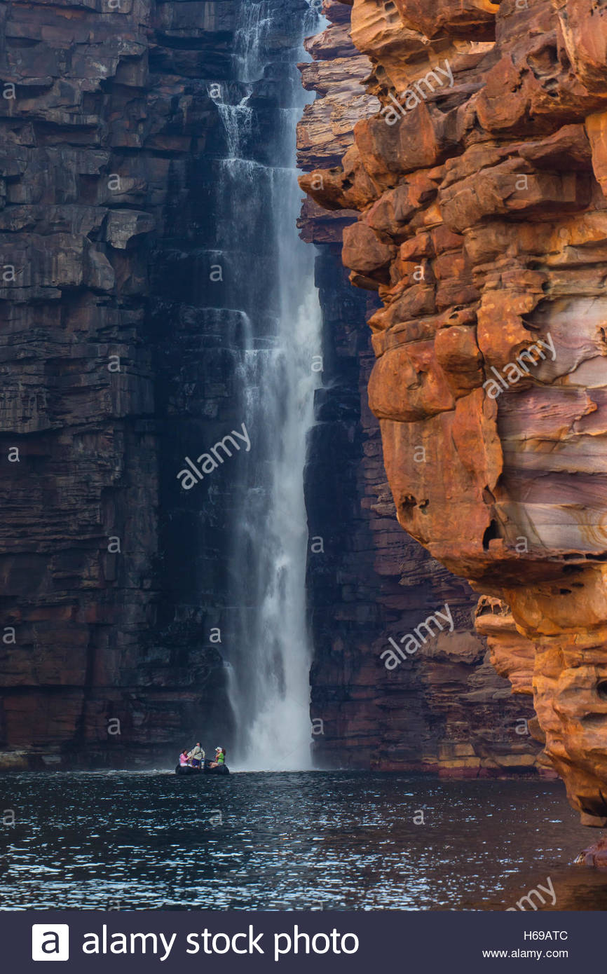 A boat near the base of a waterfall in King George Falls near Koolama ...