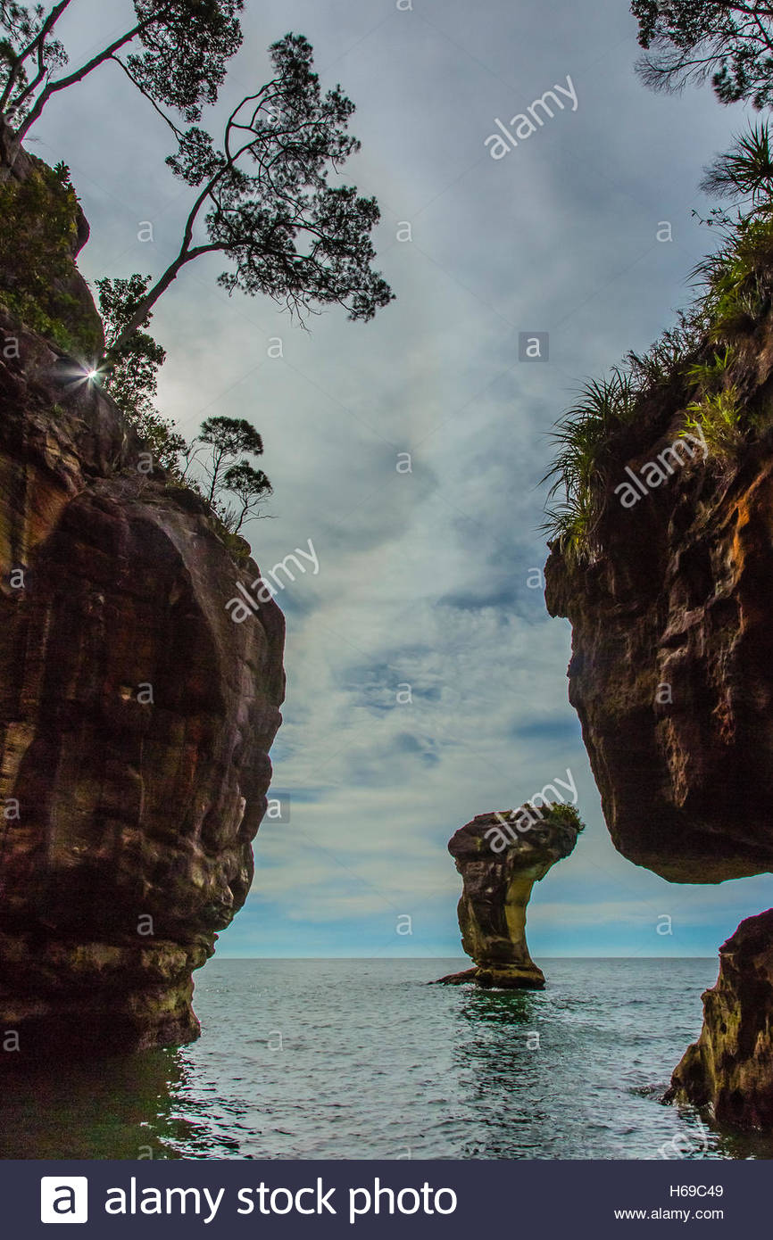 Large sandstone rock formations tower over a Malaysian beach Stock ...