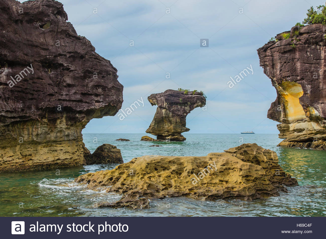 Large sandstone rock formations tower over a Malaysian beach Stock ...