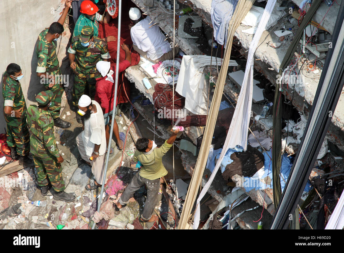 Rescue workers try to rescue trapped garment workers in the Rana Plaza ...