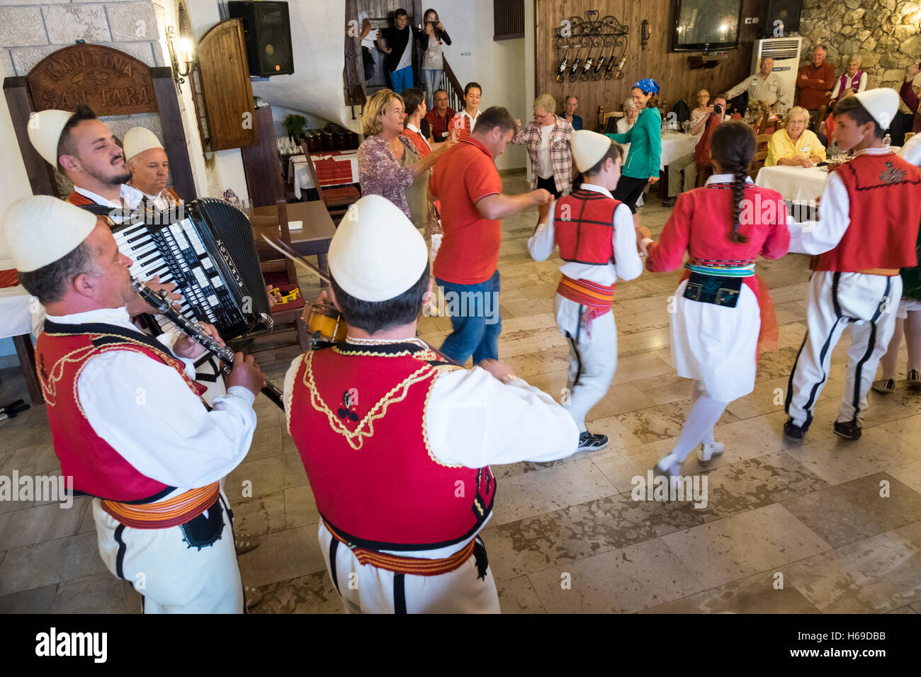 A group dressed in traditional costumes perform Albanian music and ...