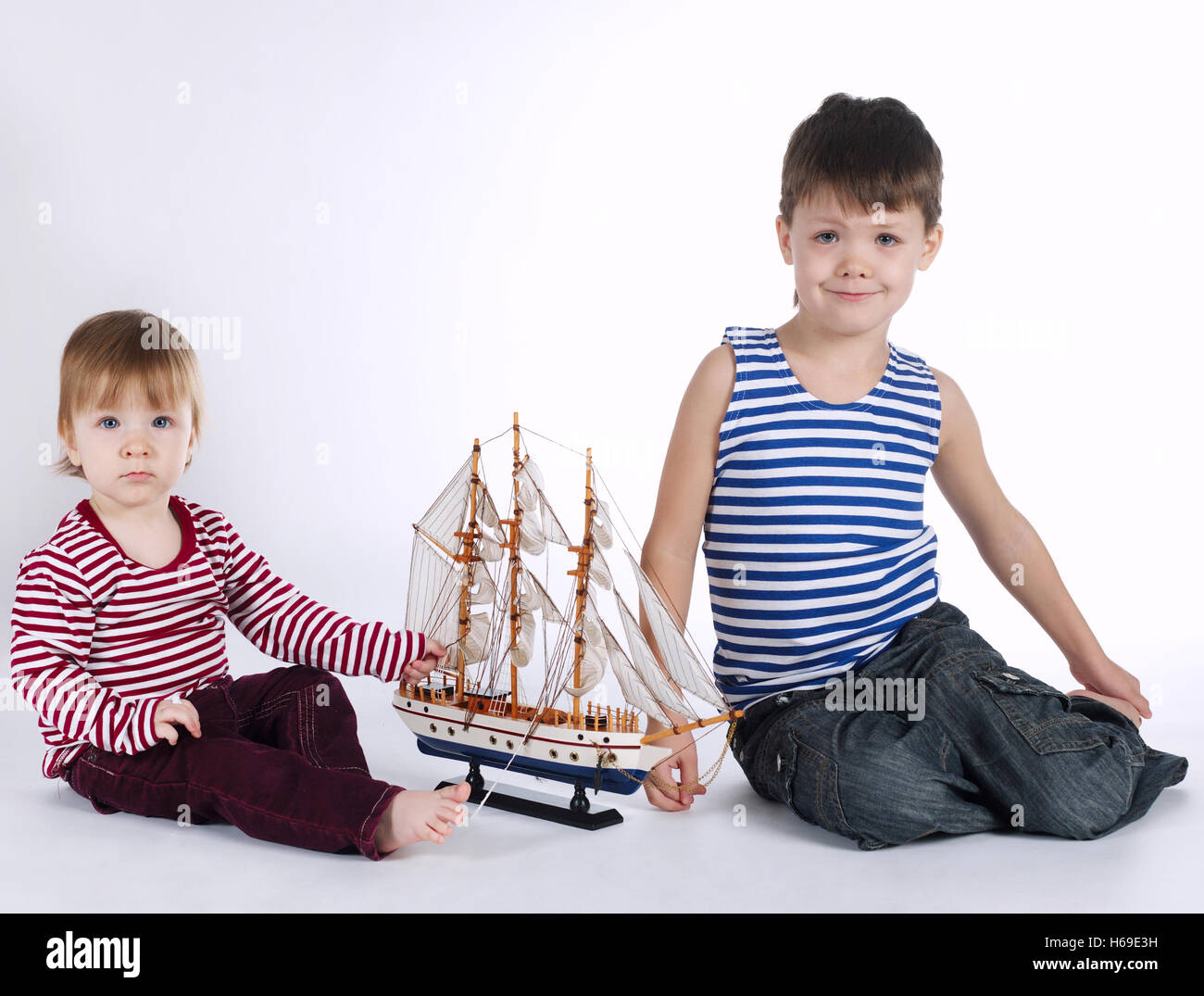 boy and girl playing with ship Stock Photo - Alamy