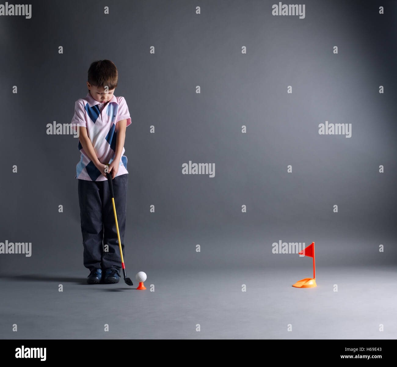little boy plays mini golf Stock Photo - Alamy