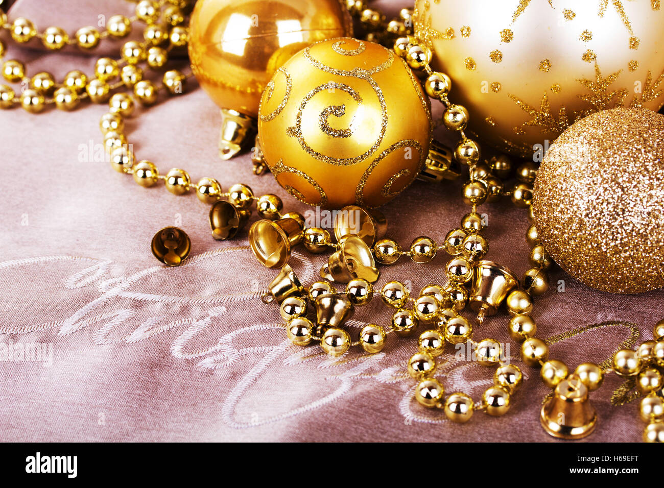 Festive gold Christmas decorations on a fabric background Stock Photo ...