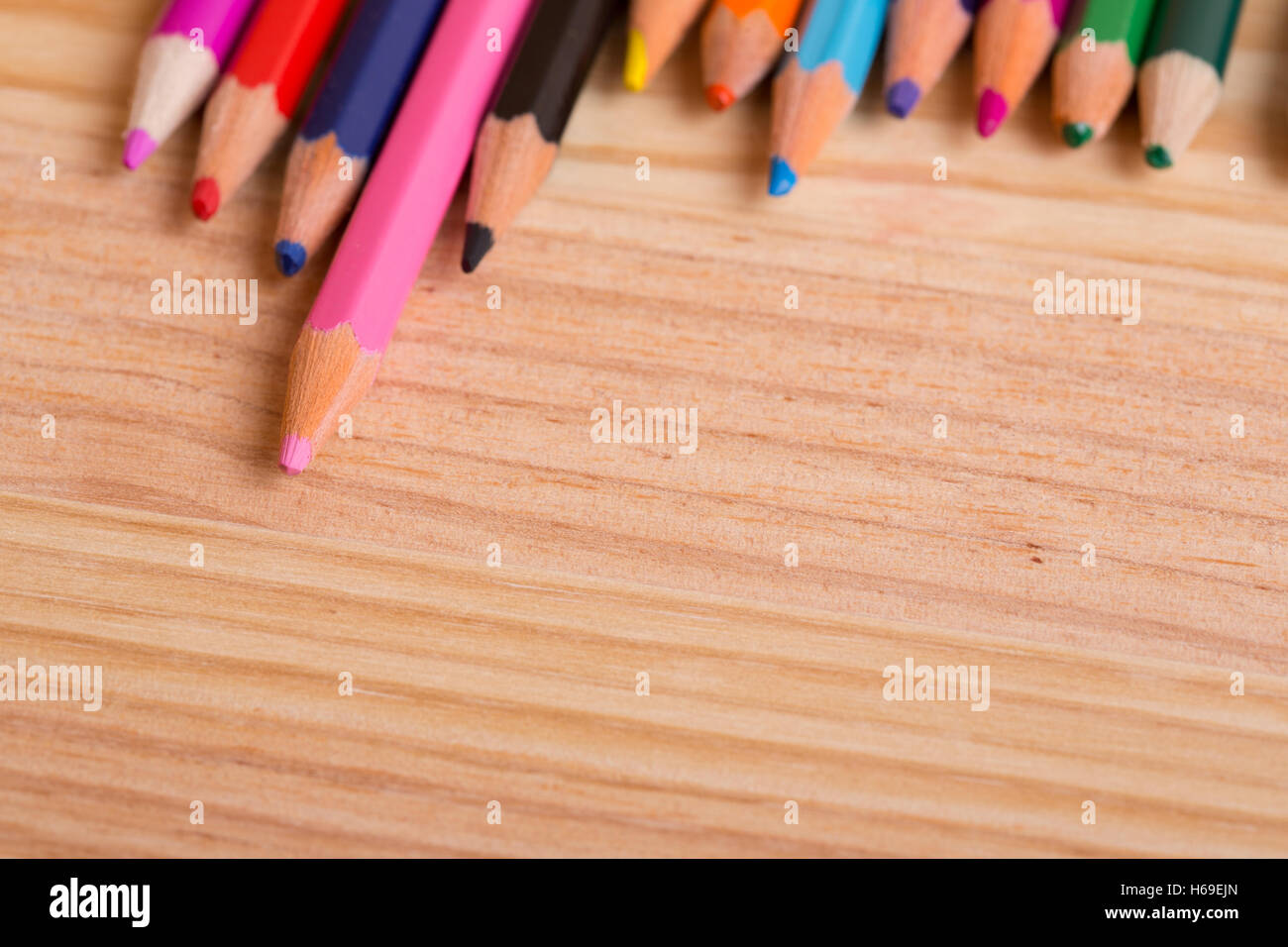 colored pencils on the wooden background Stock Photo - Alamy